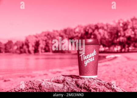 Coffee in viva magenta cup on monochrome background. Close up. Copy ...