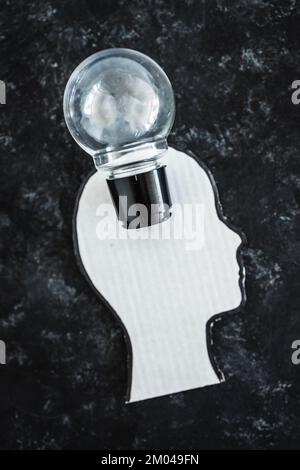 cardboard head silhouette with light bulb metaphor of ideas on my mind ...