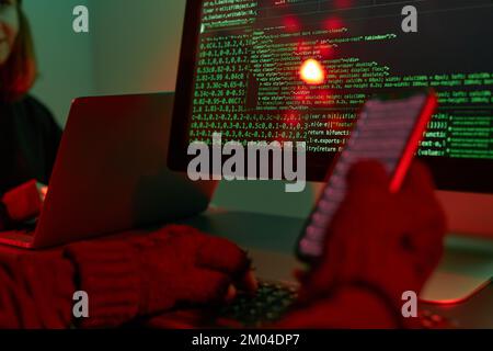 Anonymous people using computer and programming to break code. Cyber security threat. Internet ...