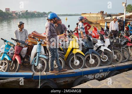 Cross river ferry arriving with boatload of passengers in in Hoi An ...