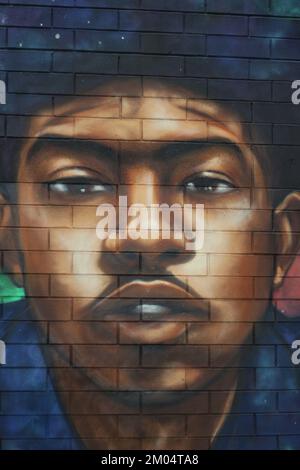 A tribute mural to Brandon McGhee spray painted on an inner city ...