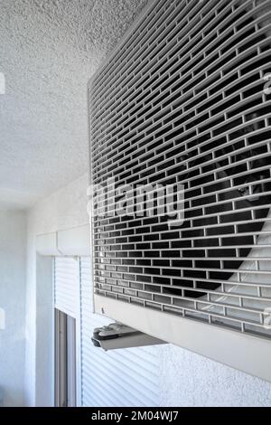 Modern wall-mounted air conditioner installed in a room, providing ...
