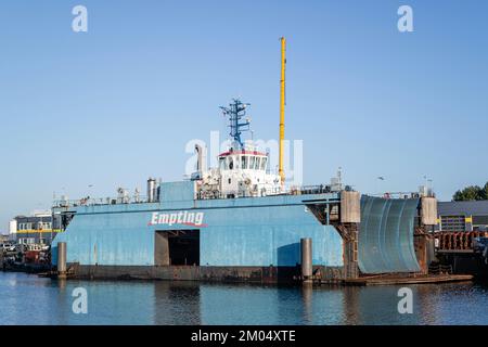 tugboat in Empting floating dock in Cuxhaven, Germany for maintenance ...
