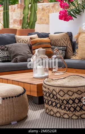 Large corner sofa with soft cushions located under elegant chandelier ...