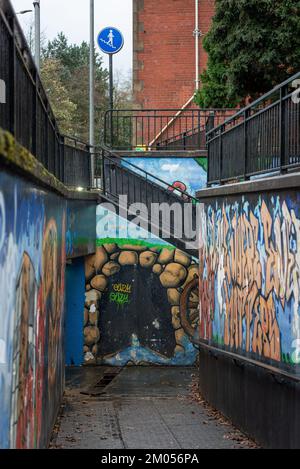 Creepy subway, dark and dingy with graffiti on the walls. Blue walls ...