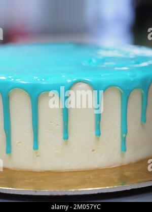 bag piping filling topping on frosted icing drip turquoise cake for ...