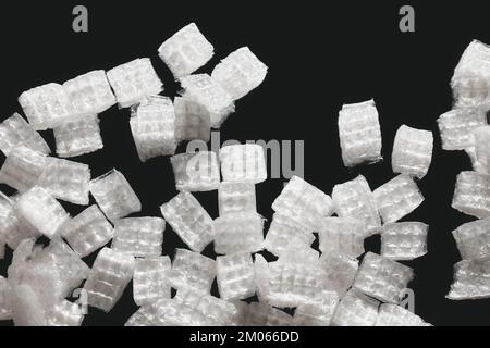 Close up picture of recycled plastic film chips on the black background ...