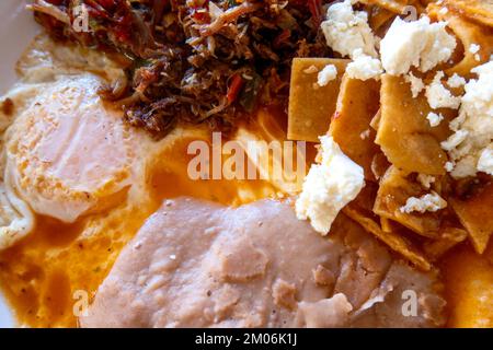A Scrambled eggs with machaca and beans and chilaquiles Stock Photo - Alamy