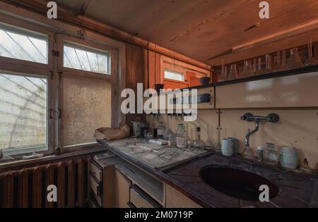 Old abandoned chemical laboratory. Long table with broken flasks Stock ...
