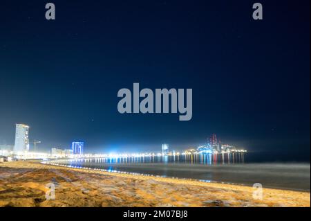 A Mazatlan sinaloa beach at night with luminous city in the background ...