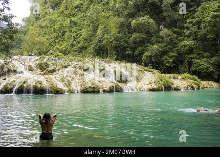 Tourist enjoys Semuc Champey. Semuc Champey is a natural monument with ...