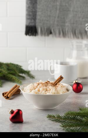 Scandinavian rice porridge with cinnamon in a bowl surrounded by ...