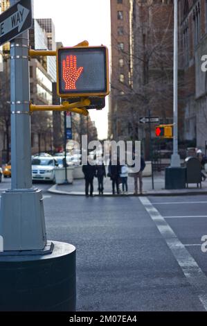 a city crossing with a semaphore on blurred background with cars in the ...