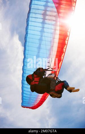 Two people paragliding in a blue sky Stock Photo - Alamy