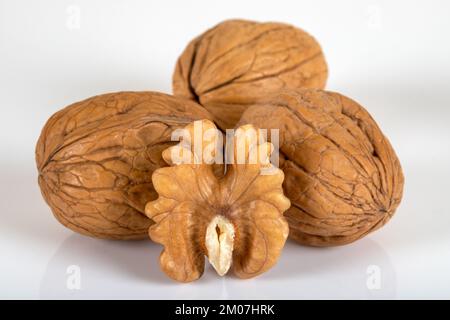 Whole shelled walnuts and cracked walnuts on wooden background Stock ...