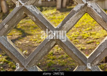 diamond shaped concrete fence close-up on a dark background. structure ...