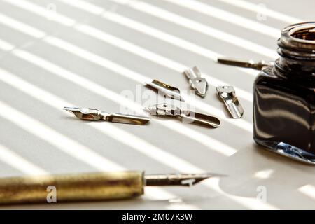 Inkpot with metal tips for the ink pen on a white background in solar ...