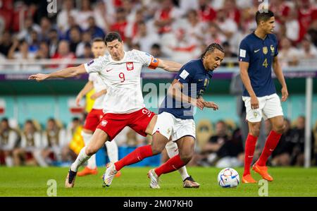 Robert Lewandowski (9) of Poland , Jules Kounde (5) of France during a ...