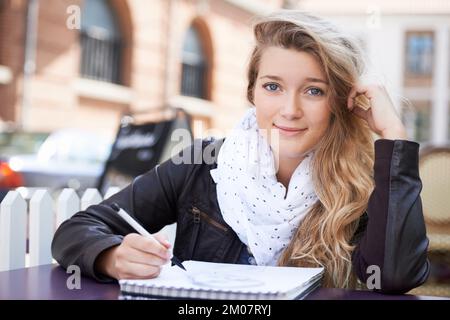 Sketching in her free time. A young woman drawing in her notepad Stock ...