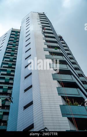 cleaning walls and glass of high-rise buildings in a big city Stock ...
