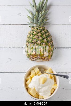 Yogurt with tropical fruits on a wooden background. Tasty breakfast ...