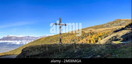 Mountain cross, view of the Lower Valais with autumn forest, Alpage de ...
