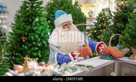 Russian santa claus pays with a credit card in a store of artificial ...