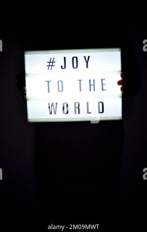 Light box with the phrase, "# Joy to the world" illuminated on it set ...