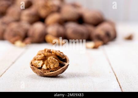 Stacked walnuts from basket on white wooden table - walnut harvest ...