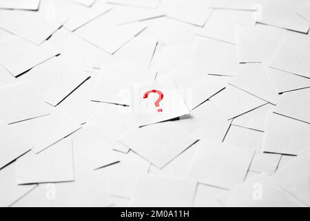 Pile of blank pieces of paper with red question mark in the middle ...