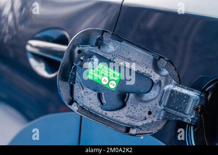 Exterior of car with fuel filler door open. Opened fuel tank cap of a ...