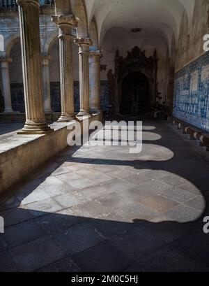 Ornate medieval arches and behind the cloister and the blue azulejo ...