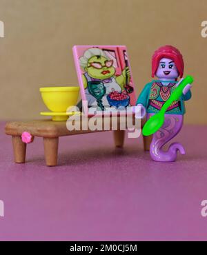 Toy female-octopus character cooking in a kitchen with a spoon and a ...