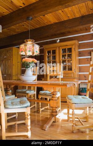 Pinewood chairs, table and furnishings in dining room inside Canadiana ...