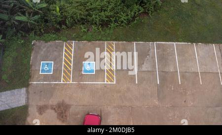 Handicapped parking space aerial view with yellow lines and asphalt ...