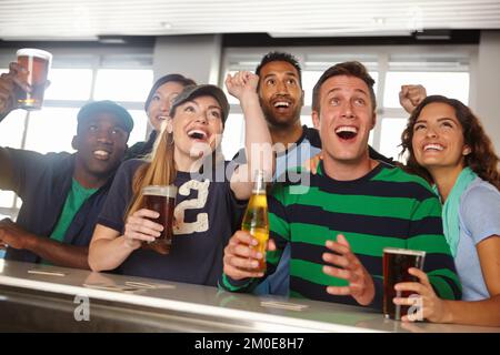Come on. A group of friends cheering on their favourite sports team at ...