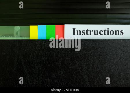 Hand picking guidelines file record in black binder folder. Work ...