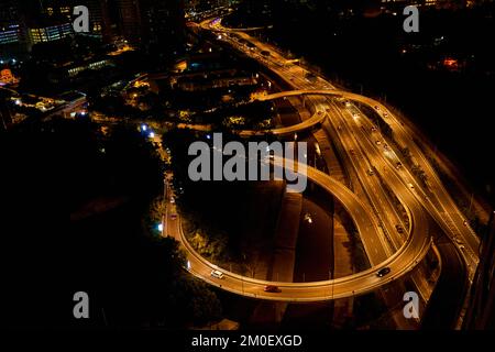 Night photo of a glowing multi-level road junction with heavy traffic ...