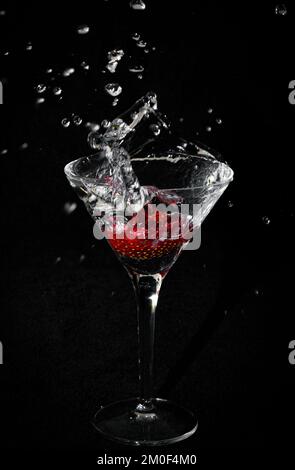 red splashing cocktail on black Stock Photo - Alamy