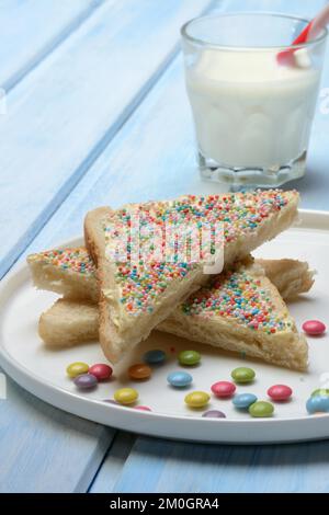 Fairy bread, toast with sugar sprinkles and glass of milk Stock Photo ...
