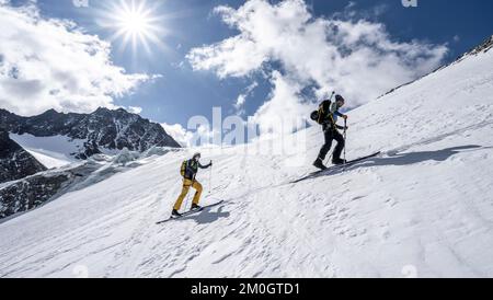 Ski tourers ascending Alpeiner Ferner, snow-covered mountain landscape ...