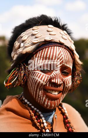 Kikuyu woman with face paint poses for photographers at Nyahururu Falls ...