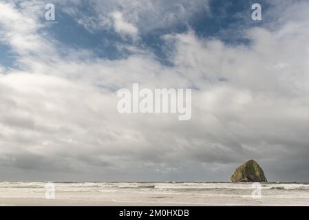 A big mossy rock formation in the sea seen from the Oregon coast in ...