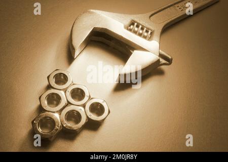 Spanner and Nuts on Warm Background Stock Photo - Alamy