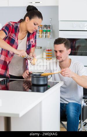 couple cooking together - man disabled on wheelchair Stock Photo - Alamy