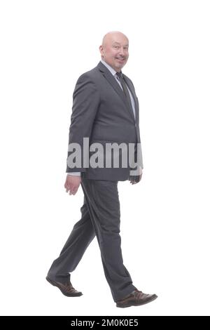 Mature business man striding forward. isolated on a white background ...