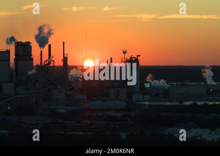 Huge factory with high chimneys polluting atmosphere with carbon ...