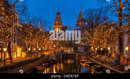 Christmas in Amsterdam canals with Christmas lights during December ...