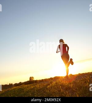 Rear view of sportswoman jogging in nature on a snowy weather. Cold ...