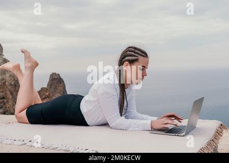Silhouette of laptop and cup on the beach over sea sunset. Sparkling ...
